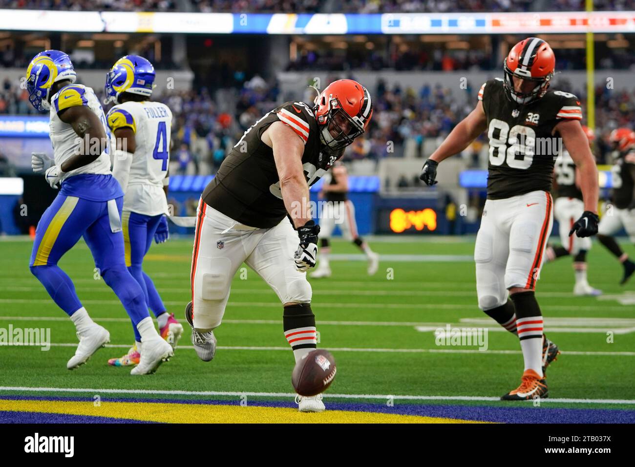 Cleveland Browns guard Michael Dunn, center, spikes the ball after ...