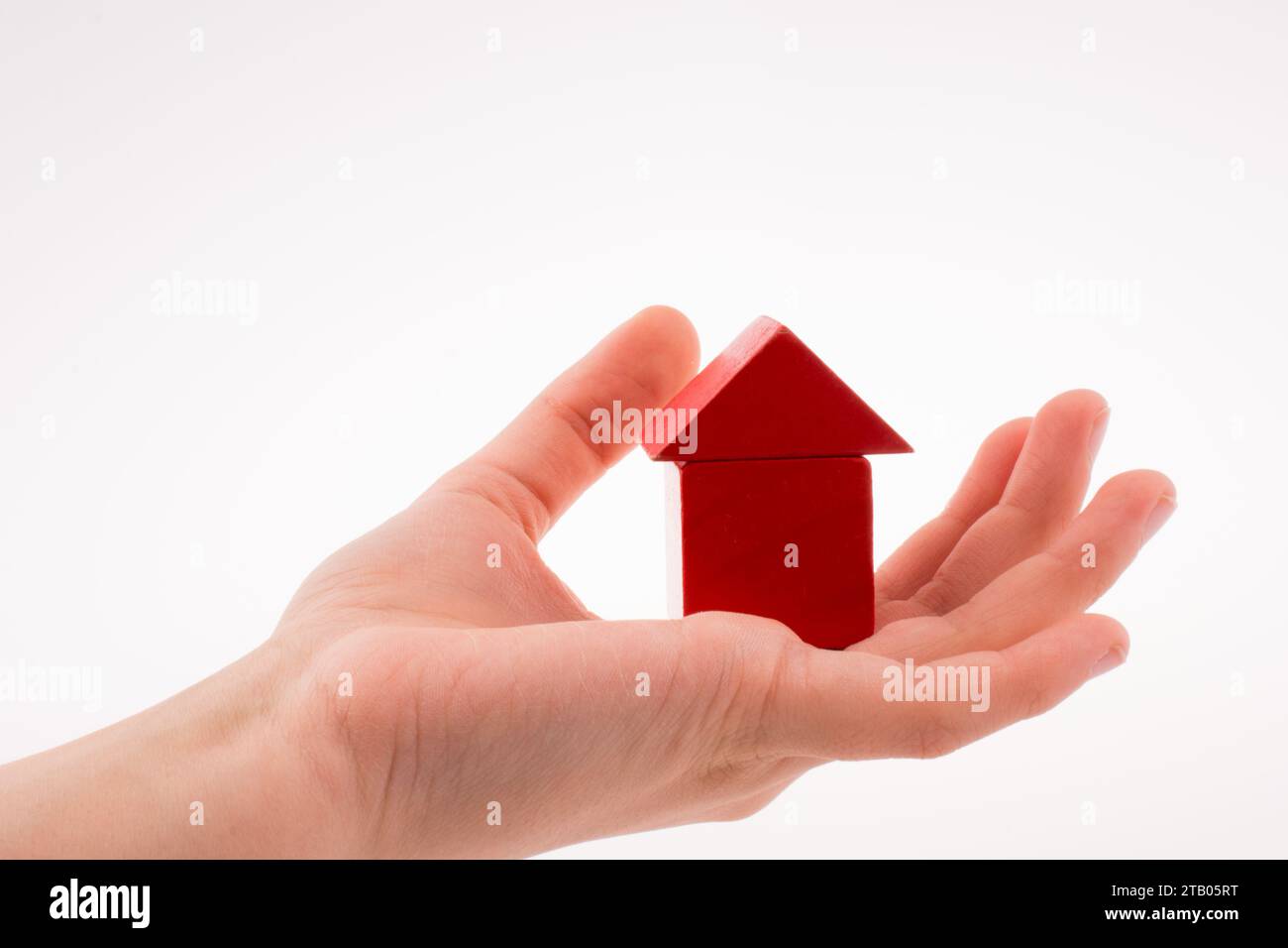 House made of colorful cubes in hand on a white background Stock Photo ...