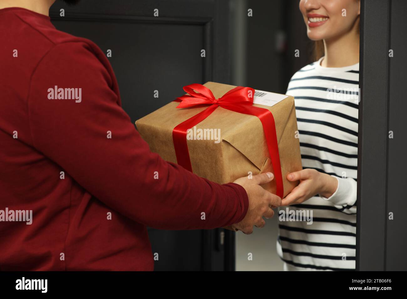 Woman surprise holiday present courier hi-res stock photography and ...