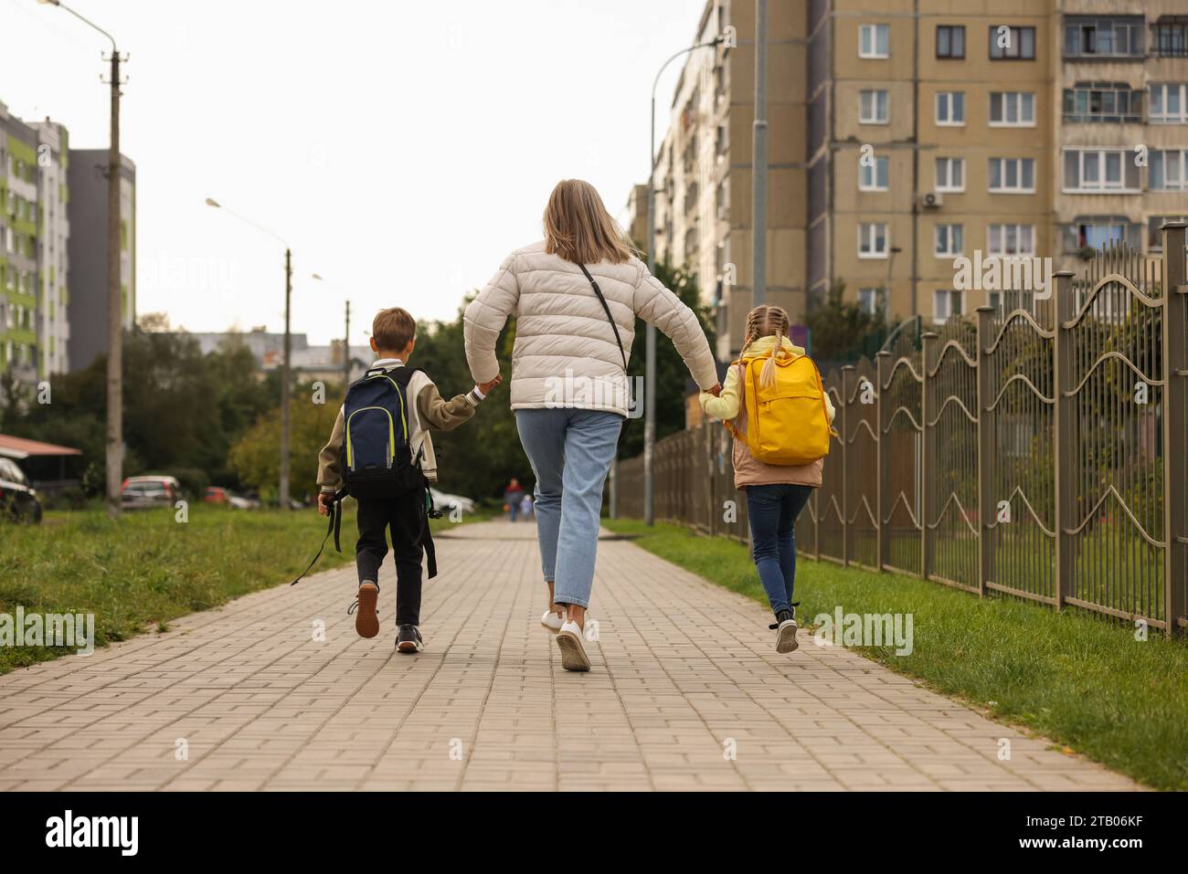 Being late for school. Senior woman and her grandchildren with ...