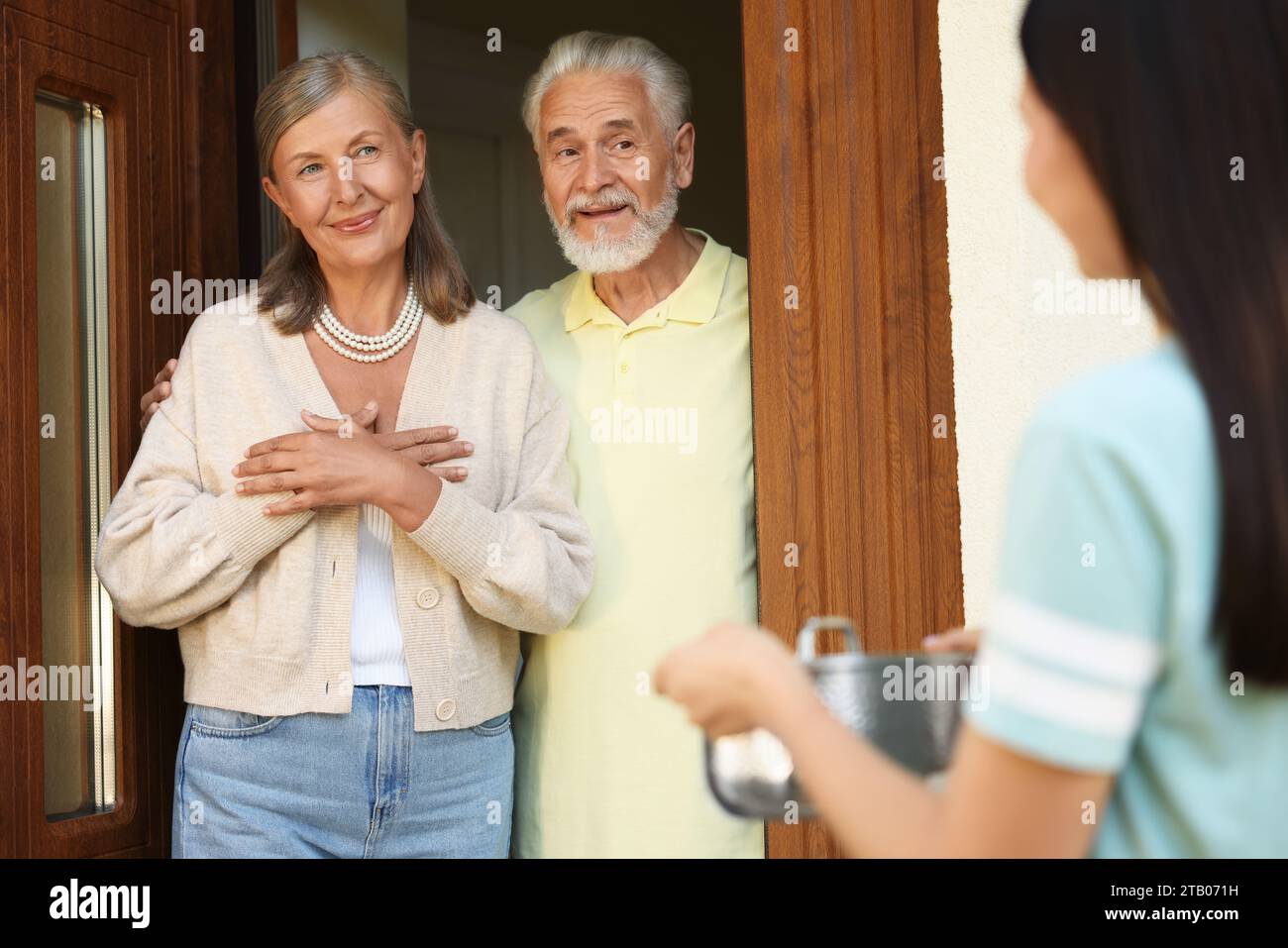 Friendly relationship with neighbours. Young woman with saucepan ...