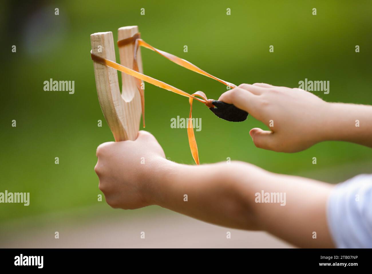 Little girl playing with slingshot outdoors, closeup Stock Photo - Alamy