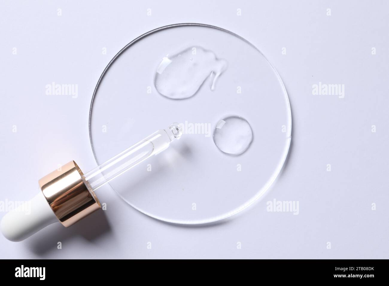 Samples of cosmetic serum and pipette on white background, top view ...