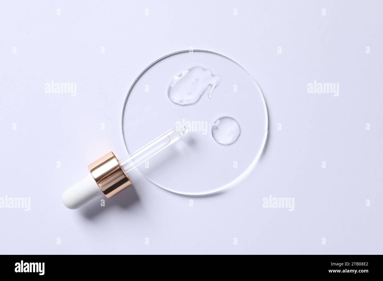 Samples of cosmetic serum and pipette on white background, top view ...