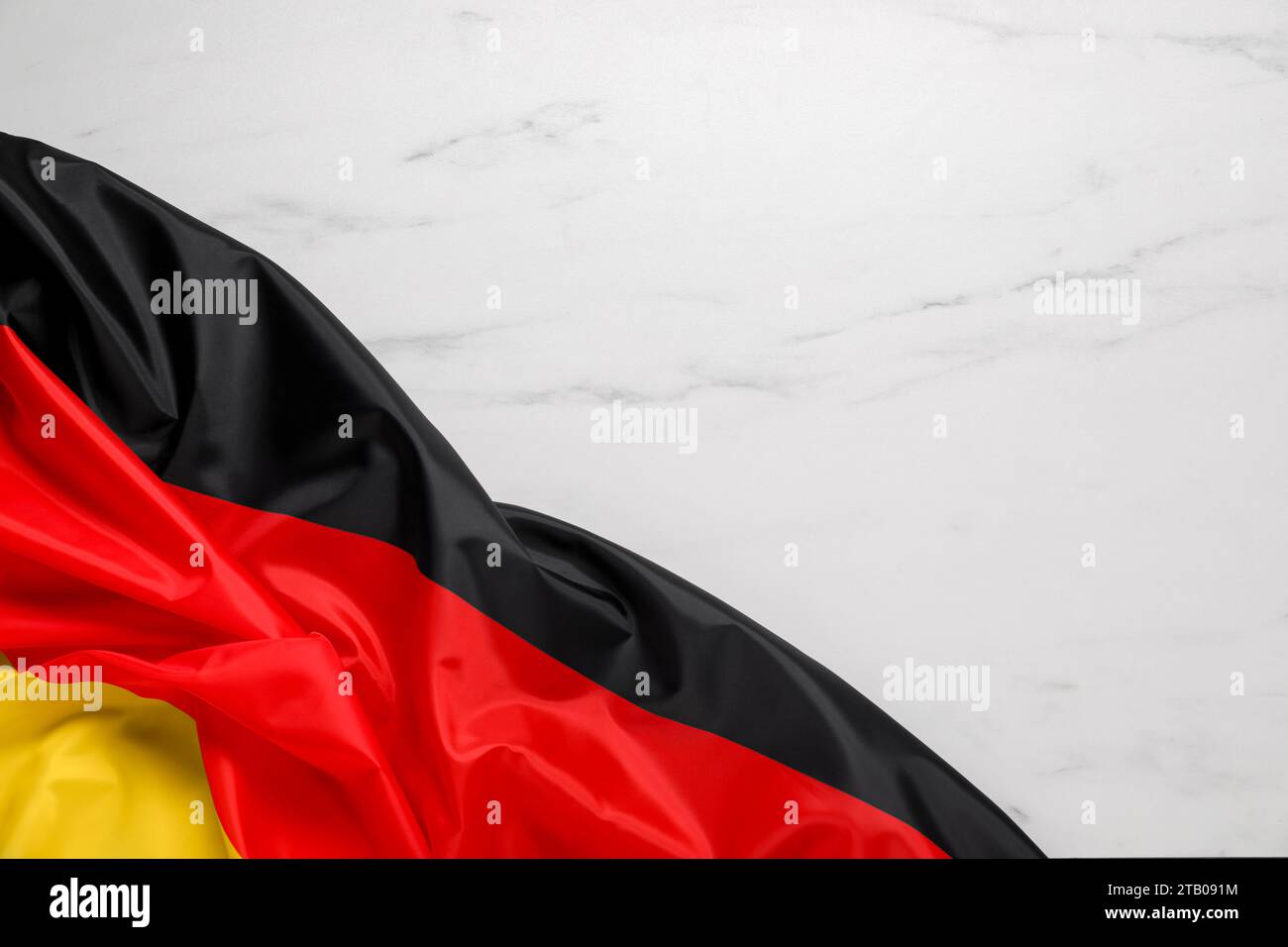 Flag of Germany on white marble background, top view. Space for text ...