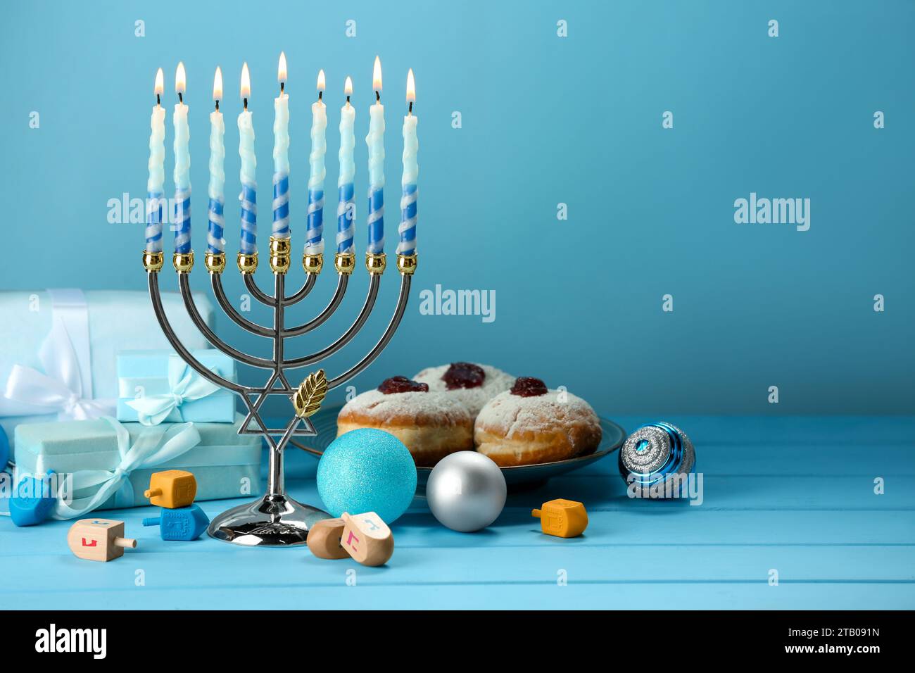 Composition with Hanukkah menorah, dreidels, donuts and gift boxes on ...