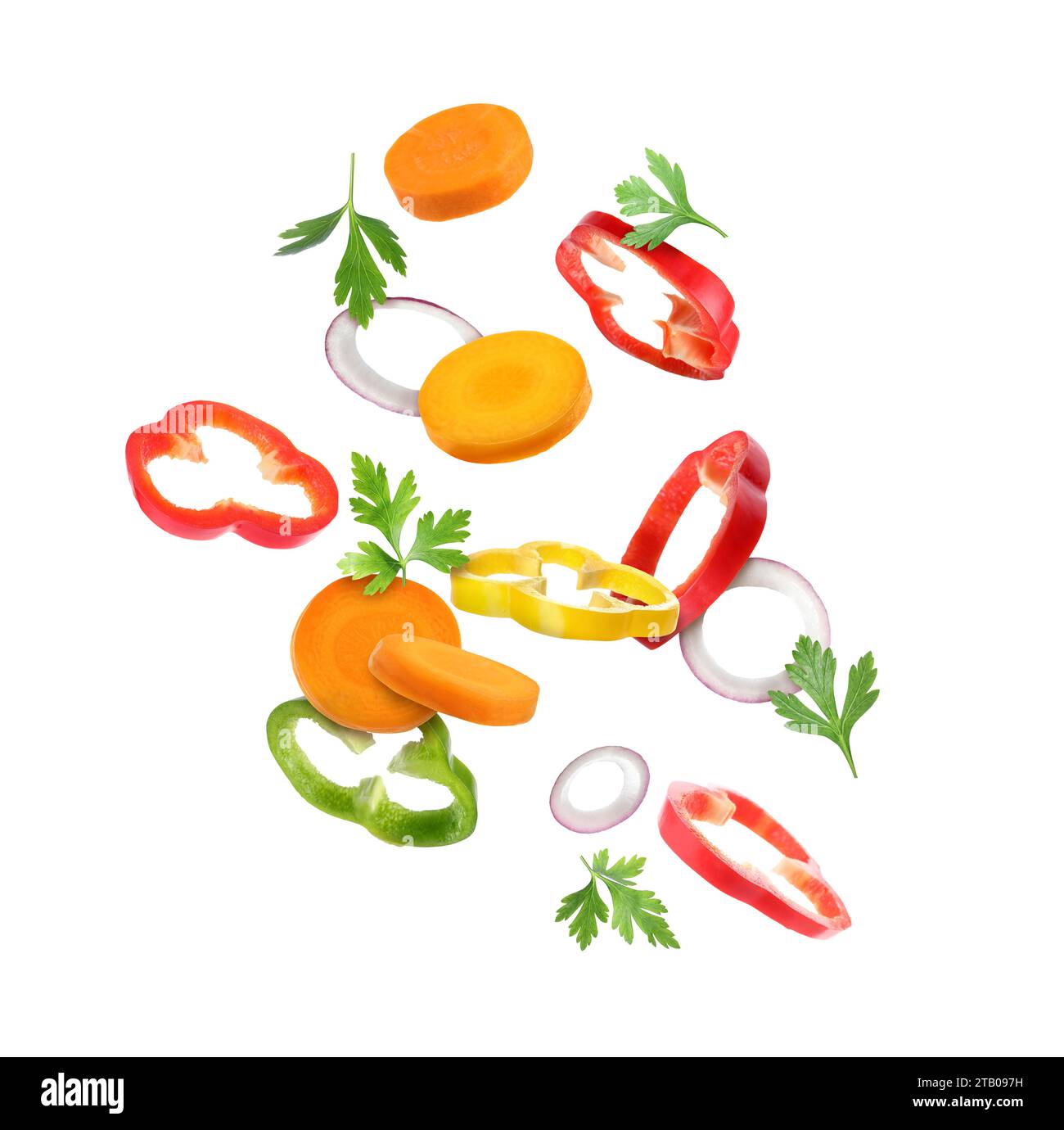 Fresh parsley, bell pepper, onion and carrot flying on white background ...