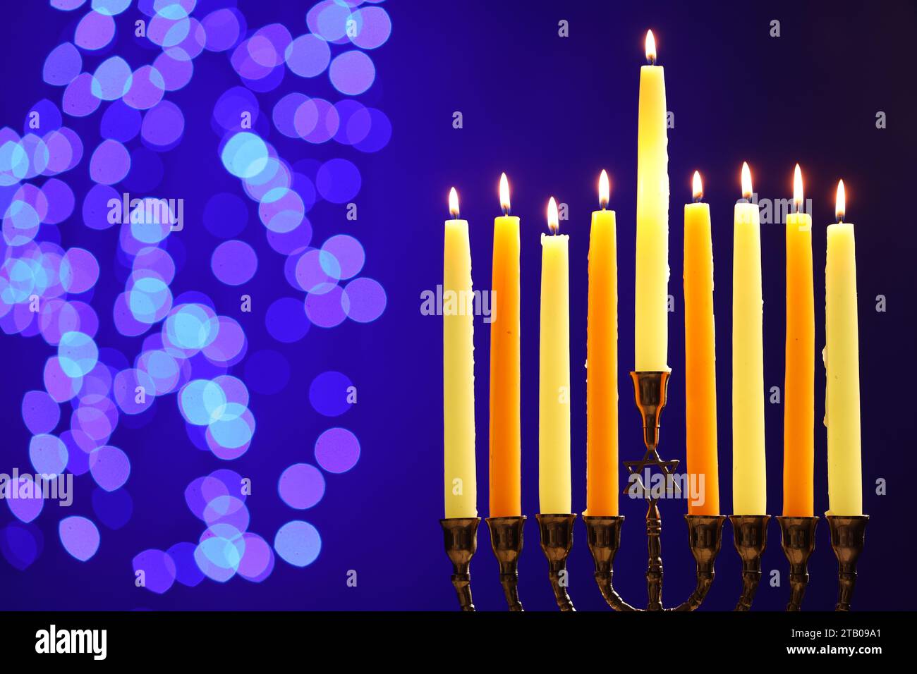 Hanukkah celebration. Menorah with burning candles on blue background ...