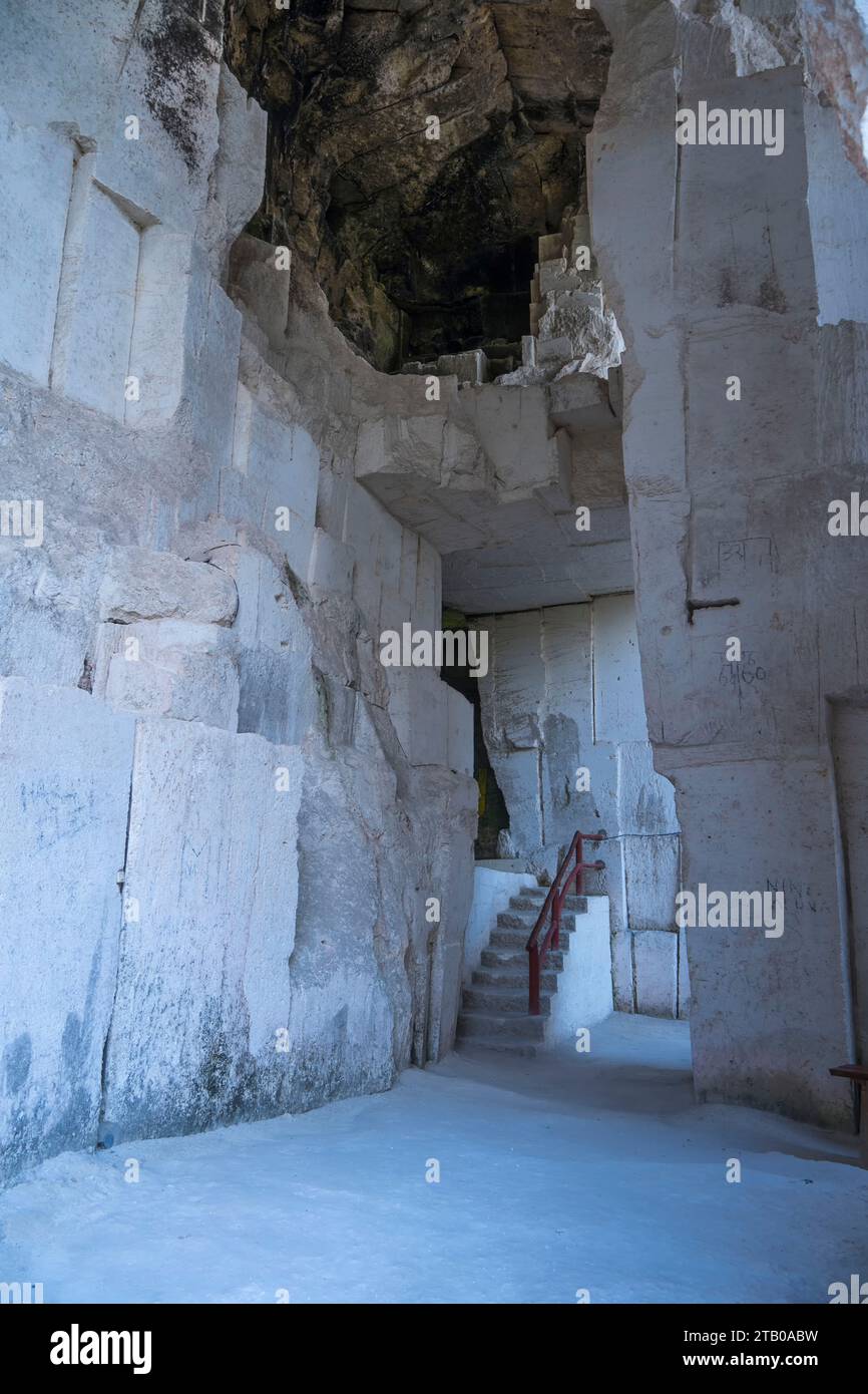 Limestone steps ascend a moss covered wall, leading to a mysterious ...