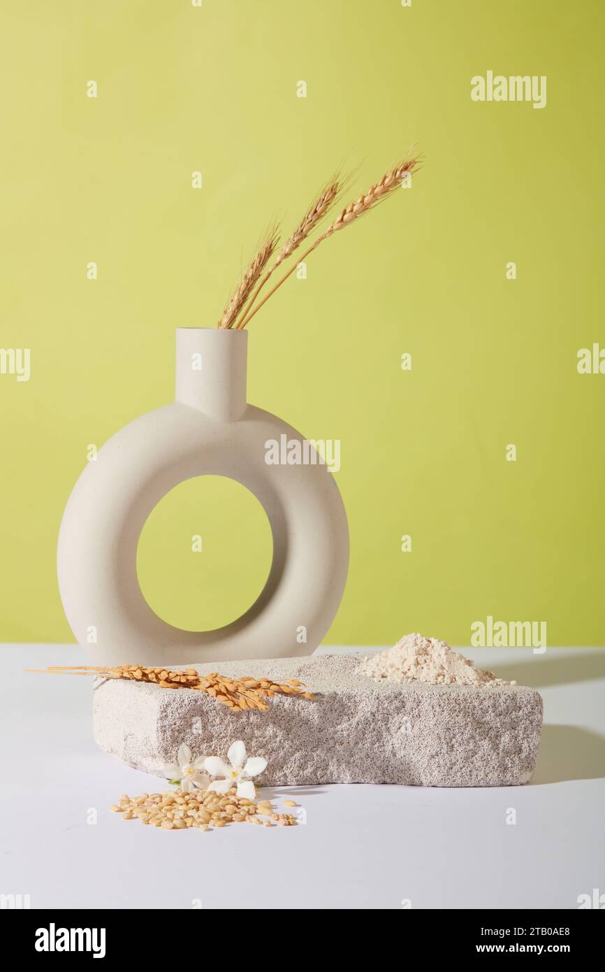 A uniquely shaped flower vase and whole grain rice are displayed on a ...