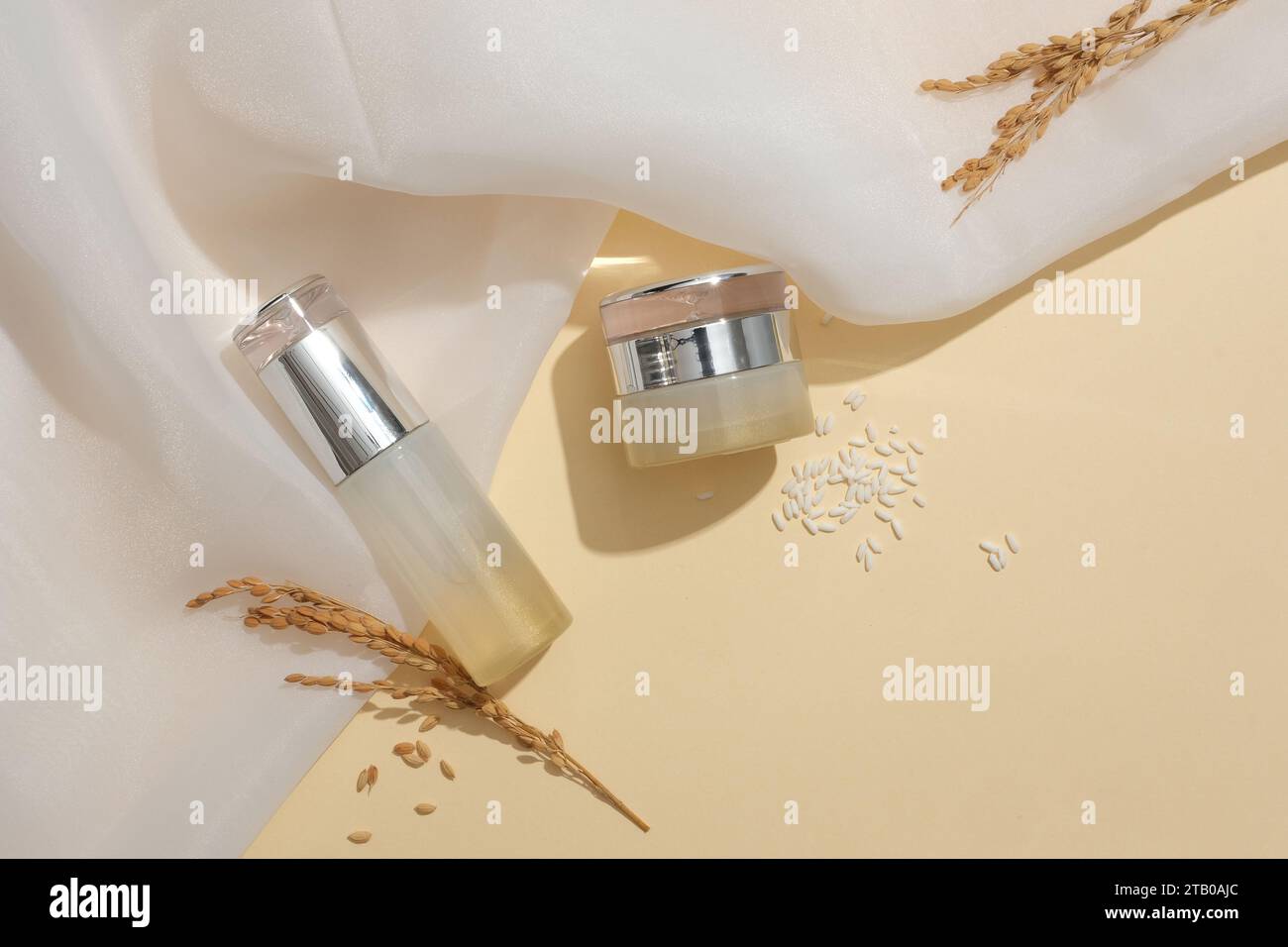 A set of high-end cosmetics without labels is displayed on a beige ...