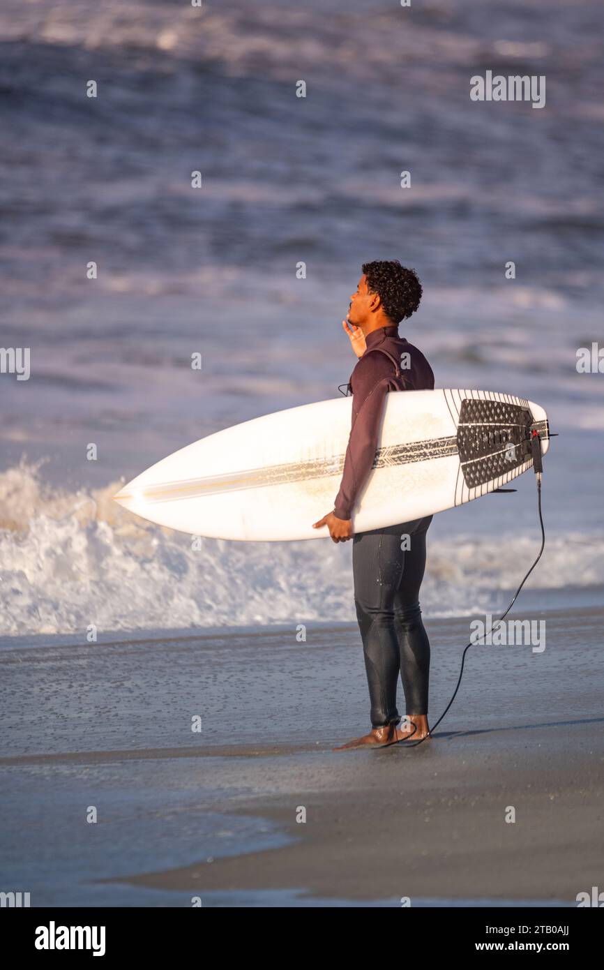 Surfer thanks God before entering the ocean Stock Photo - Alamy