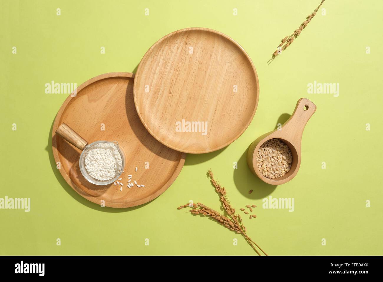 Wooden trays are placed on a green background for product display. Rice ...