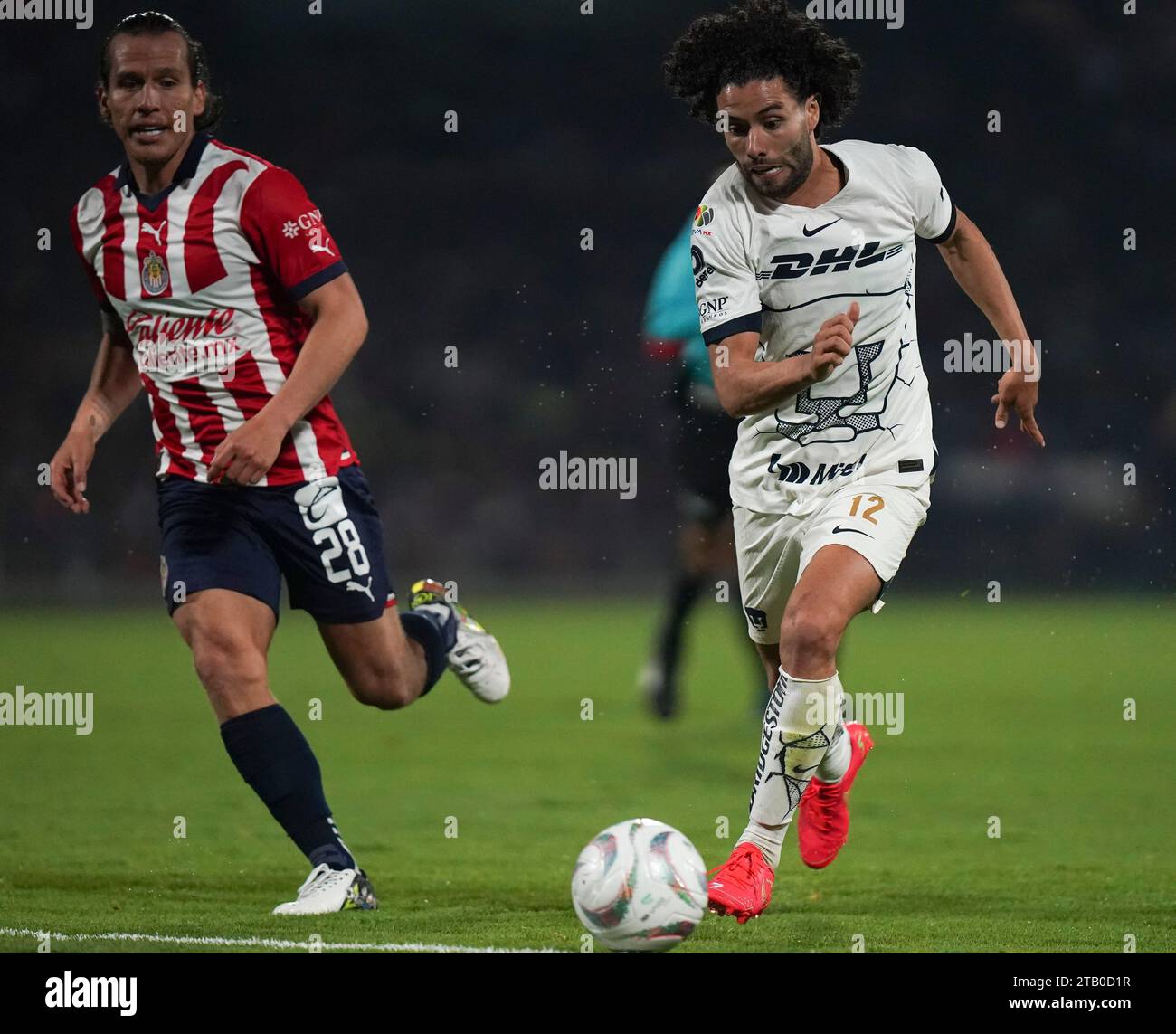 Pumas' Cesar Huerta, right, controls the ball against Chivas' Fernando ...
