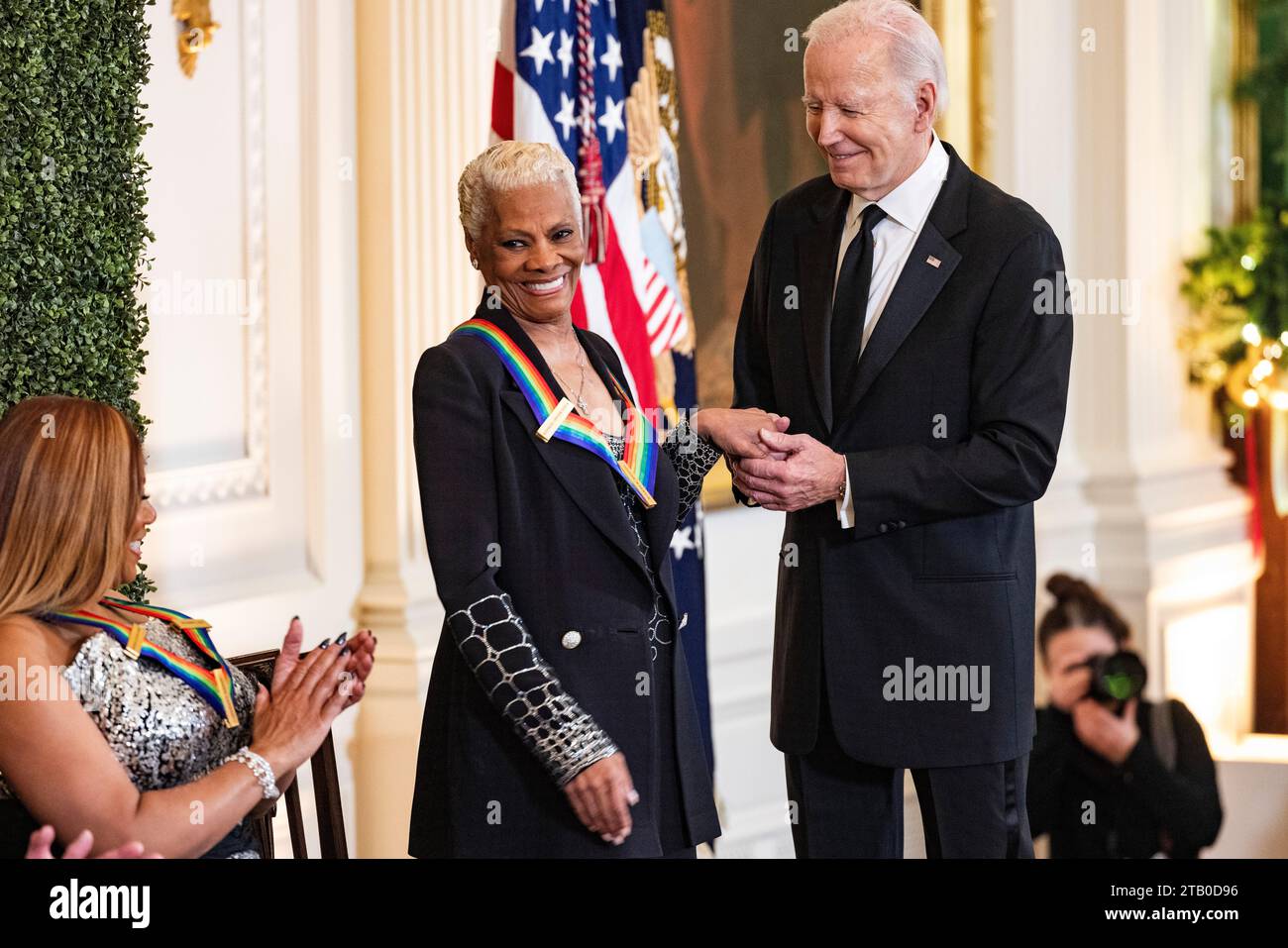 Washington, DC, USA. 03rd Dec, 2023. US President Joe Biden (R) helps ...