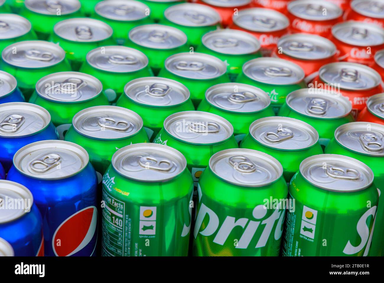 Many aluminum cans of sparkling drinks Sprite, Coca-Cola, Pepsi staying ...