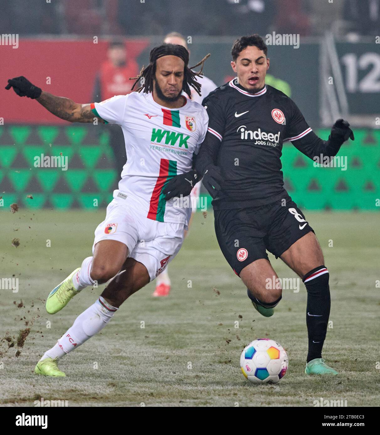 Augsburg. 4th Dec, 2023. Kevin Mbabu (L) of FC Augsburg vies with Fares ...