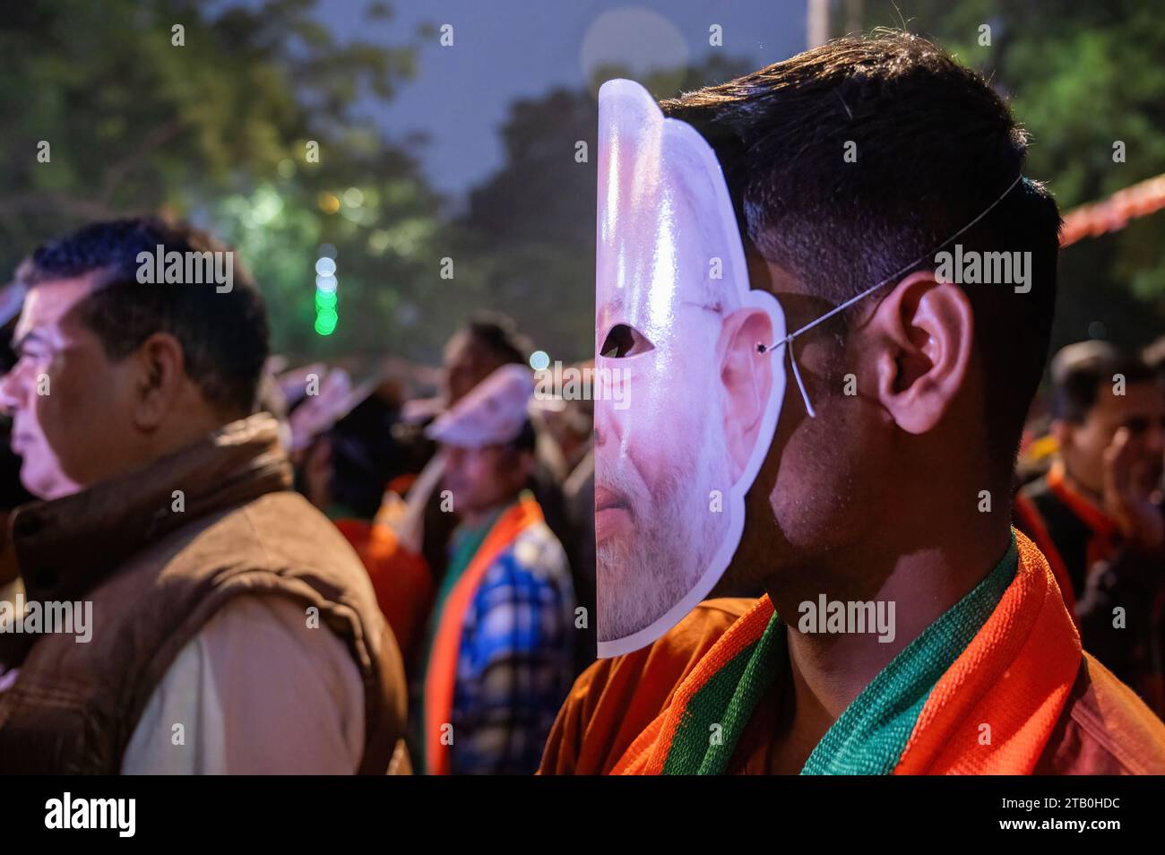New Delhi, India. 03rd Dec, 2023. A BJP supporter wears a Narendra Modi mask while celebrating ...