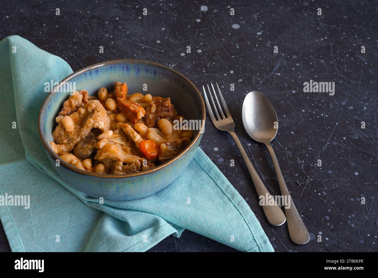 Tripas- Tripe stew with bread on the black background Stock Photo - Alamy