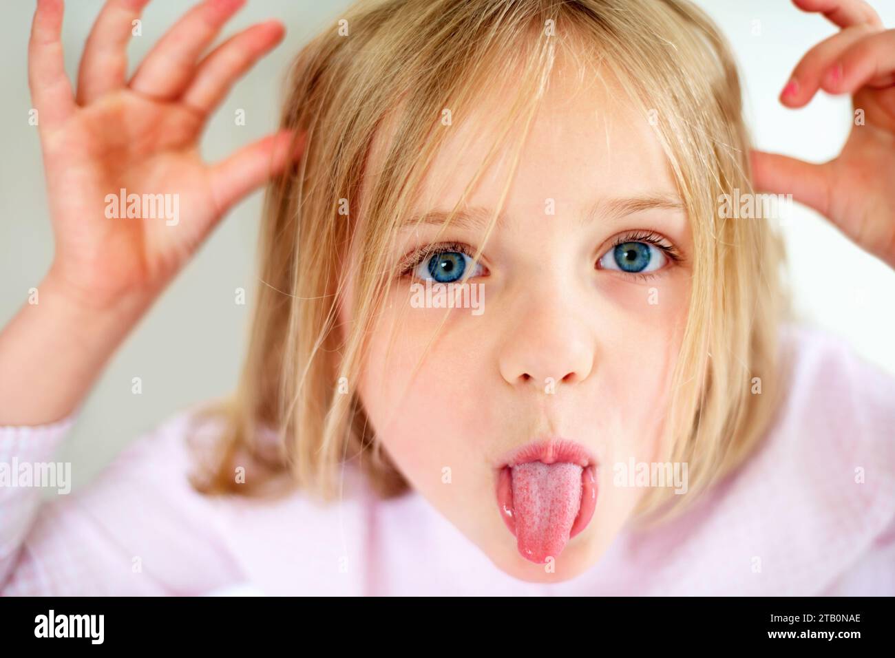 Silly, tongue out and portrait of child in home with funny, comic and ...