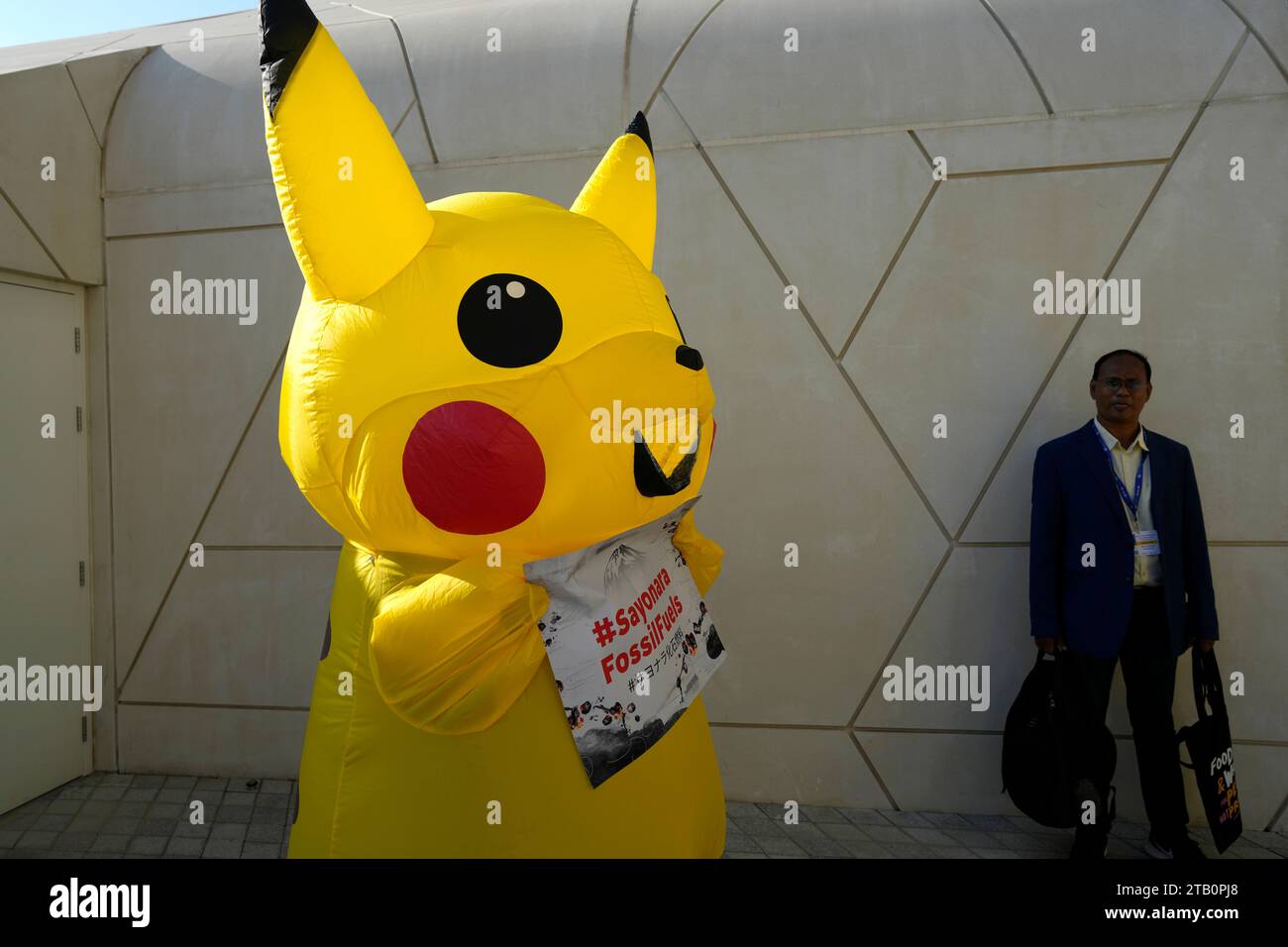 A person dressed as pikachu protests fossil fuels at the COP28 U.N ...