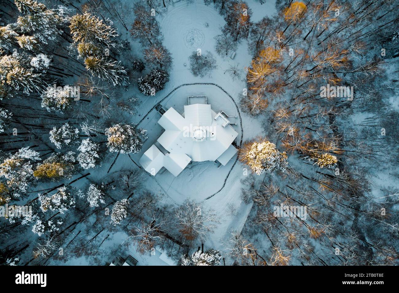 Aerial view of the snow-covered roof of a house with a turret in the ...
