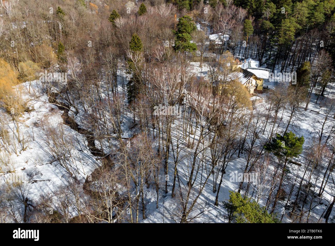 An aerial winter landscape with a view of a stream running through a ...