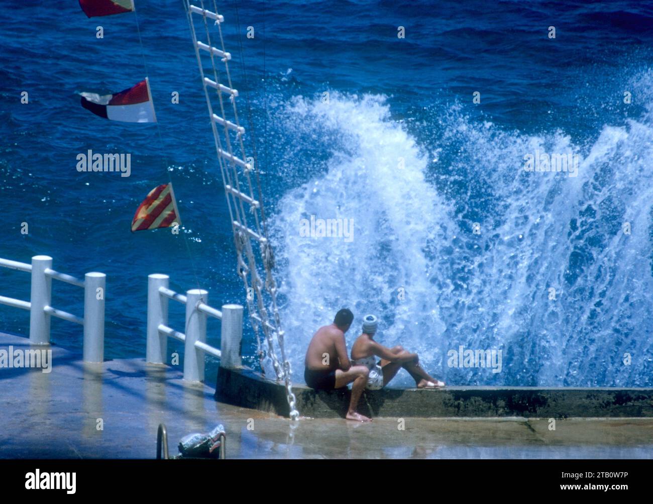 LAKELAND, FL - AUGUST, 1955: A group of people get hit by waves ...