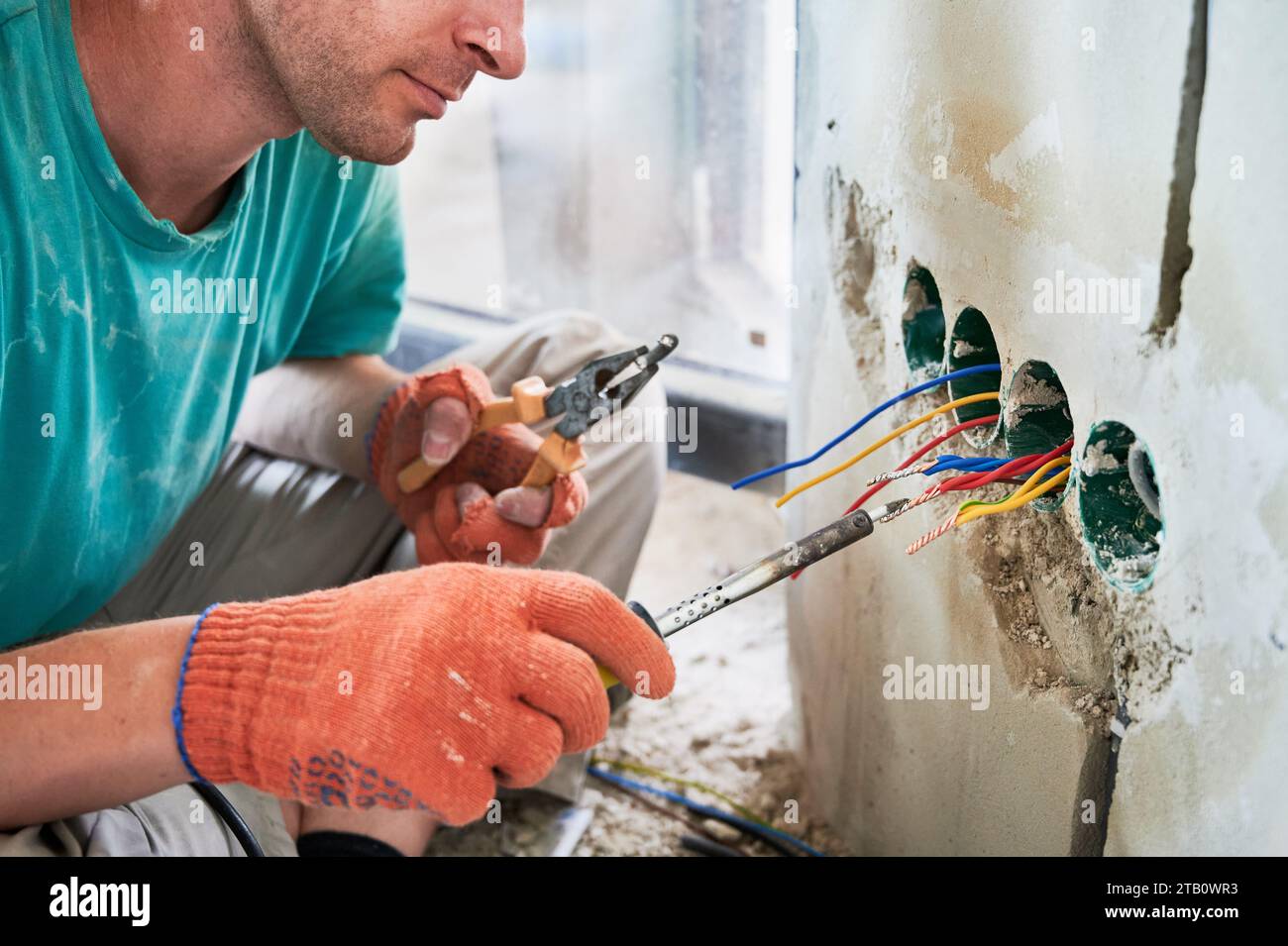 Close up of man in work gloves using welding repair tool while ...