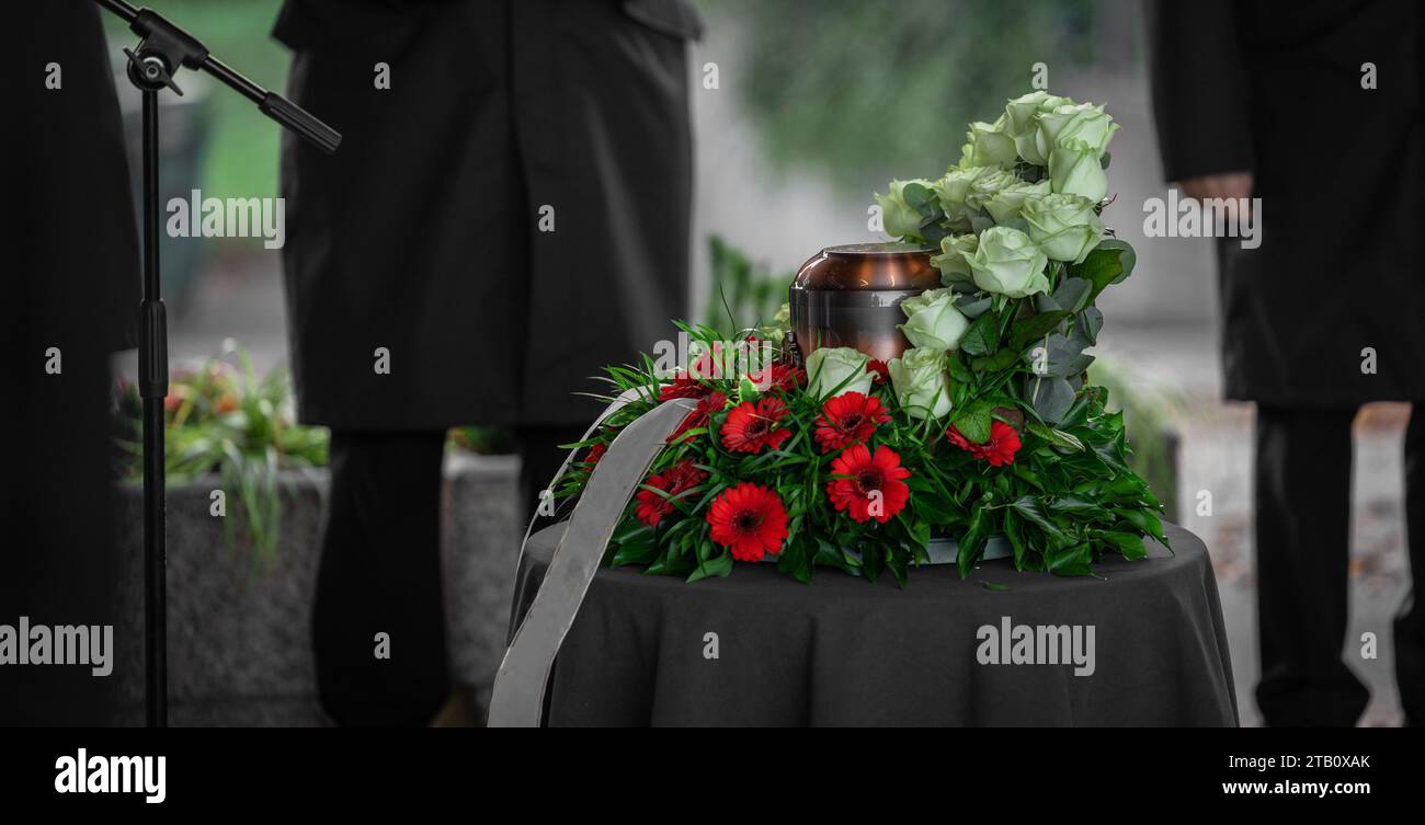 Metal urn or funeral container with ash of a deceased person at a ...