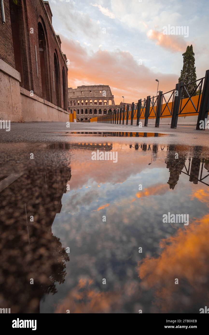Early morning view of the colosseum in rome, with red clouds rising ...