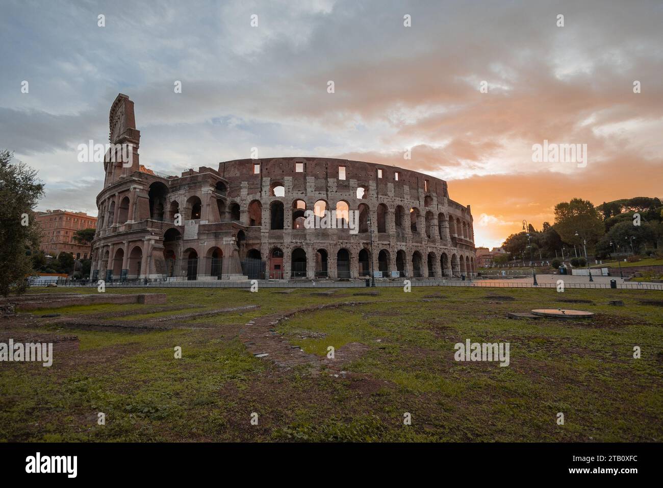 Early morning view of the colosseum in Rome, red and blue skies with ...
