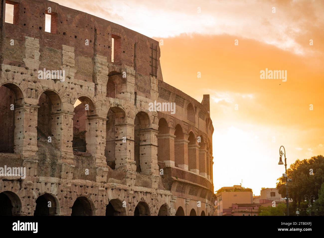 Early morning view of the colosseum in Rome, red and blue skies with ...