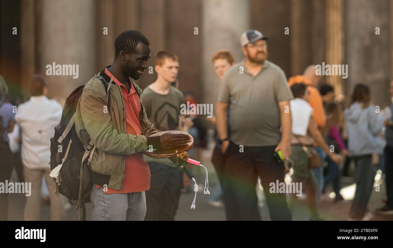 ROME, ITALY, 31.10.2023: African immigrant is selling wooden plates ...