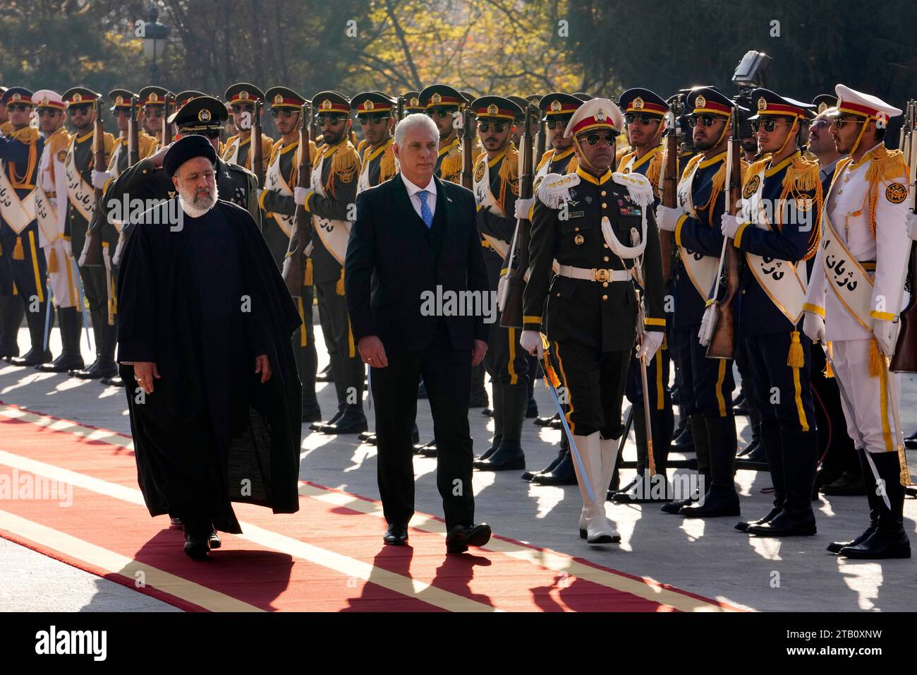 Cuban President Miguel Díaz-Canel, center, reviews an honour guard as ...
