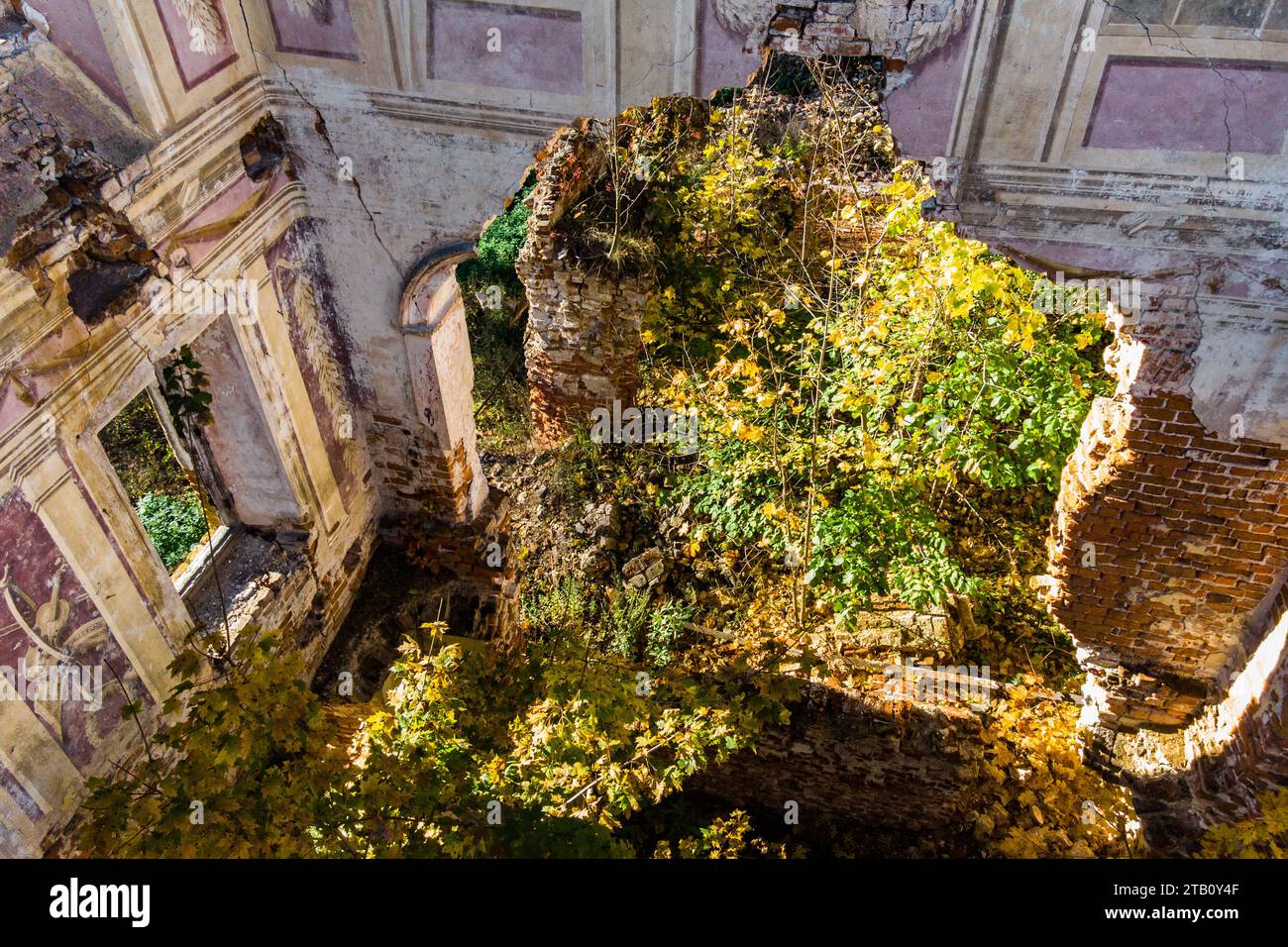 A crumbling wall of an abandoned manor house with ancient frescoes ...