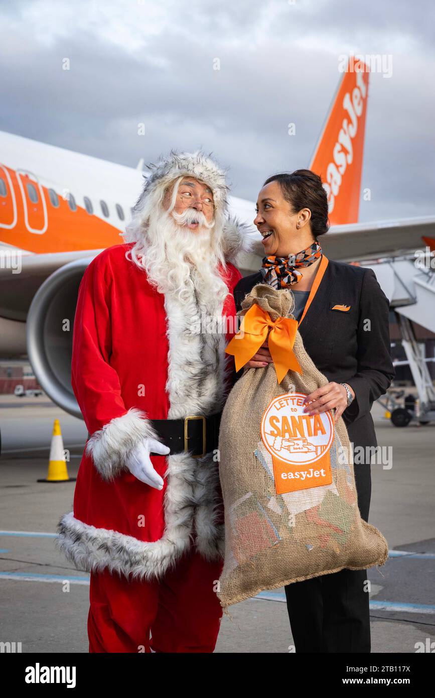 EDITORIAL USE ONLY (Left to right) Father Christmas with Cabin Crew Eva ...
