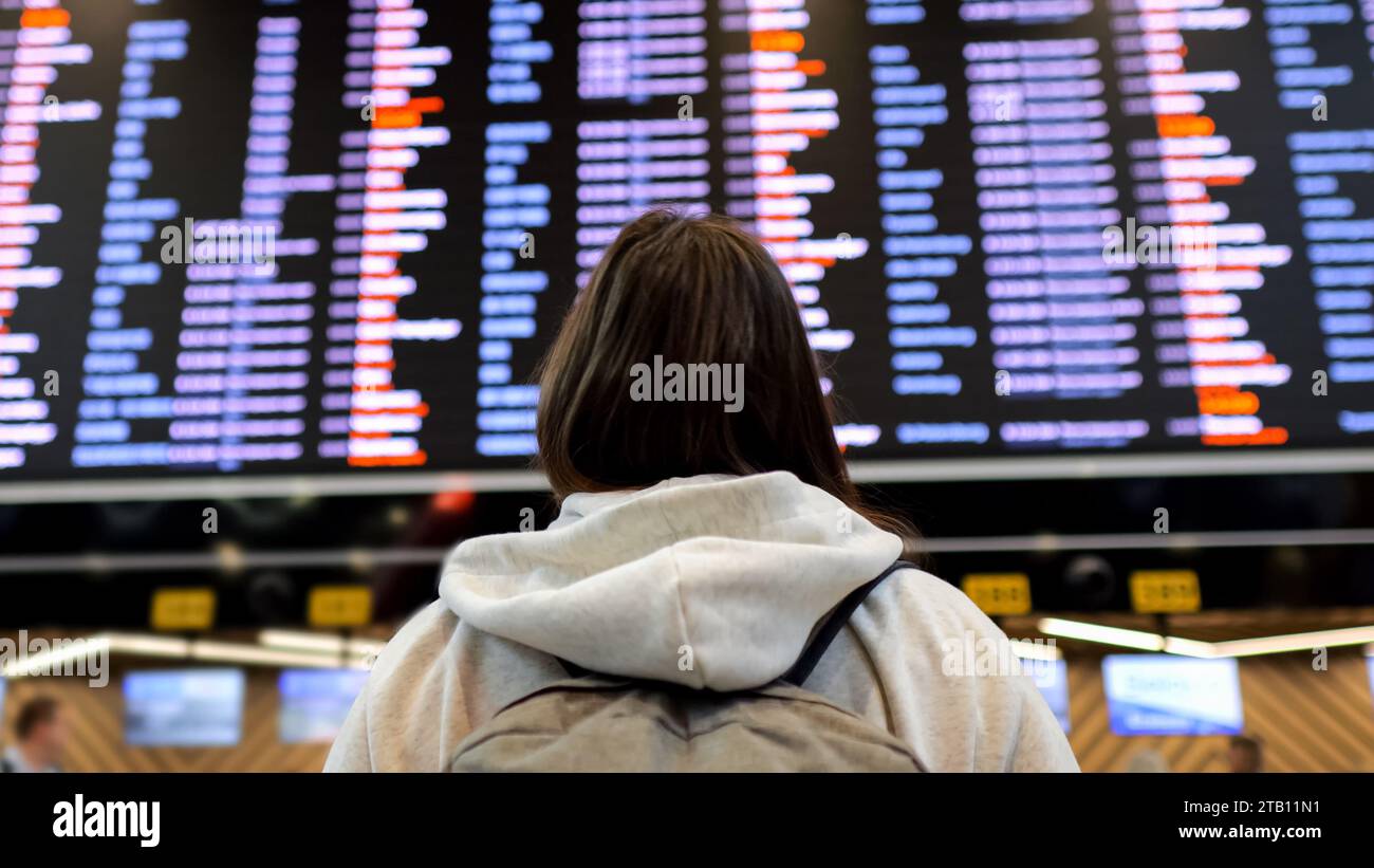 Woman looks flight information hi-res stock photography and images - Alamy