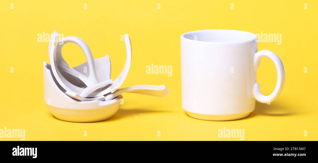 Broken cup isolated on a solid yellow background Stock Photo - Alamy