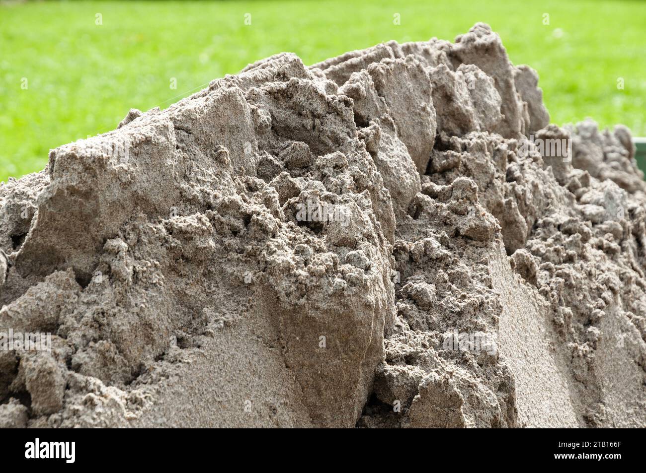 A close-up of a pile of sand in front of a green background Stock Photo ...