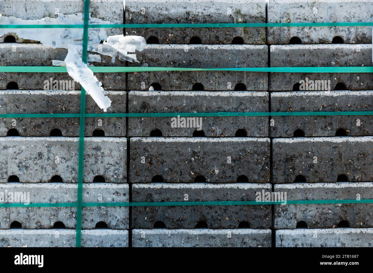 A stack of grey concrete slabs with green ribbons Stock Photo - Alamy