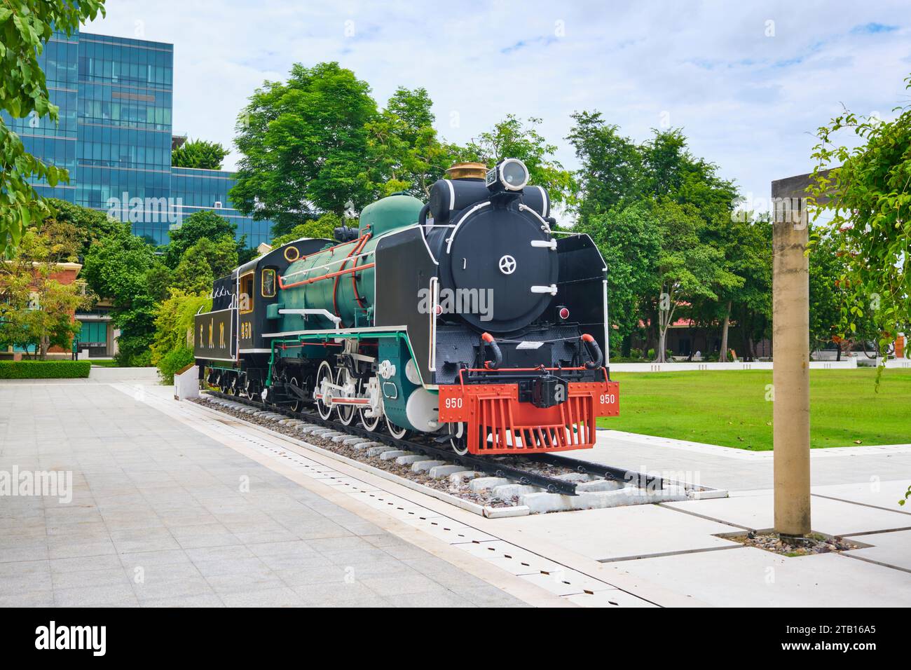On display, a restored, black, old, steam locomotive train. At the ...
