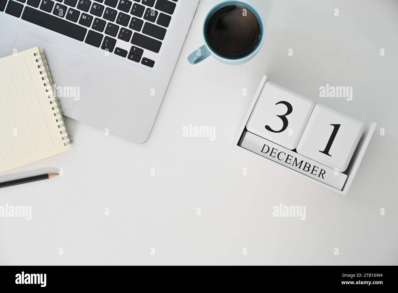 Wooden block calendar with the date December 31 on white background ...