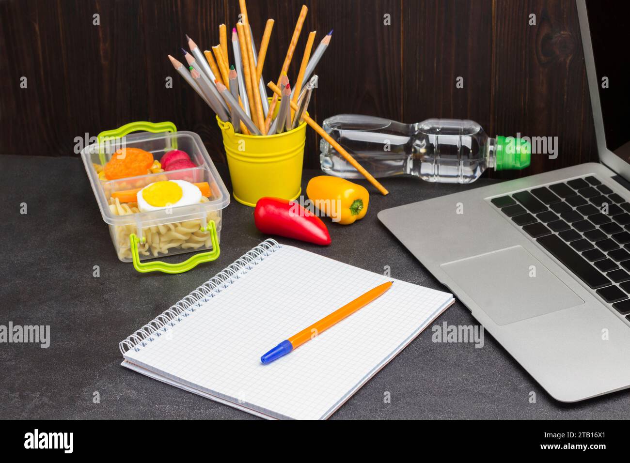 Yellow pen on notebook with springs. Bottle of water. Launch Box ...
