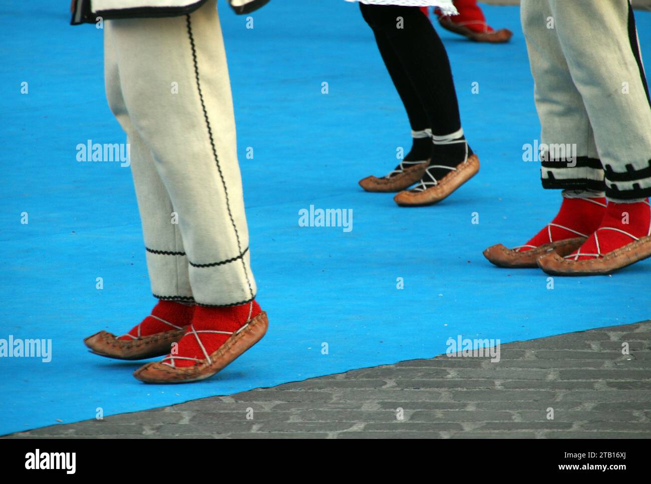 A group of people performing a traditional Balkan folk dance in a ...