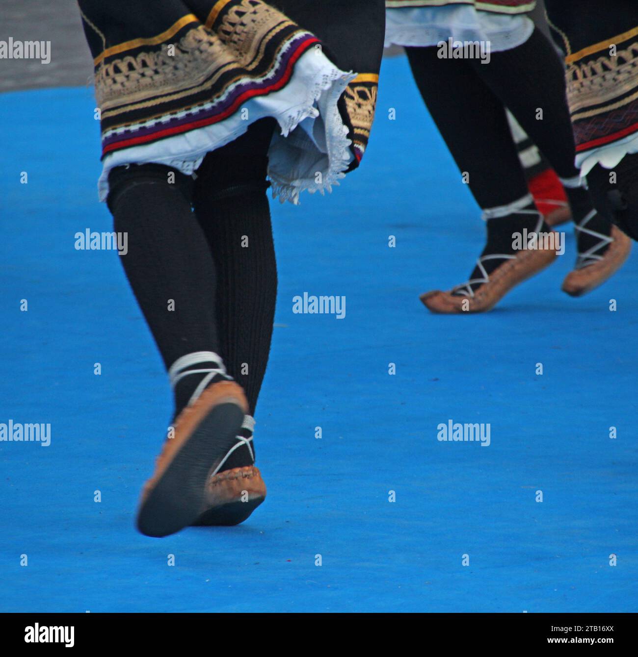 A group of people performing a traditional Balkan folk dance in a ...