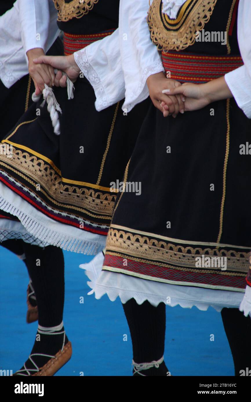 A group of people performing a traditional Balkan folk dance in a ...