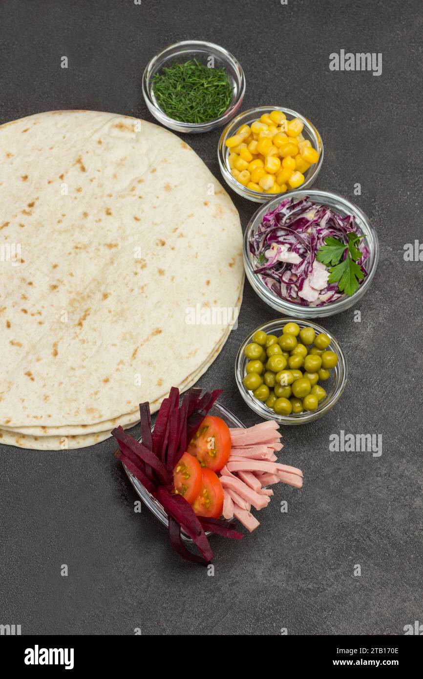 Vegetables filling for tortilla in glass bowls. Tortilla wraps. Black ...
