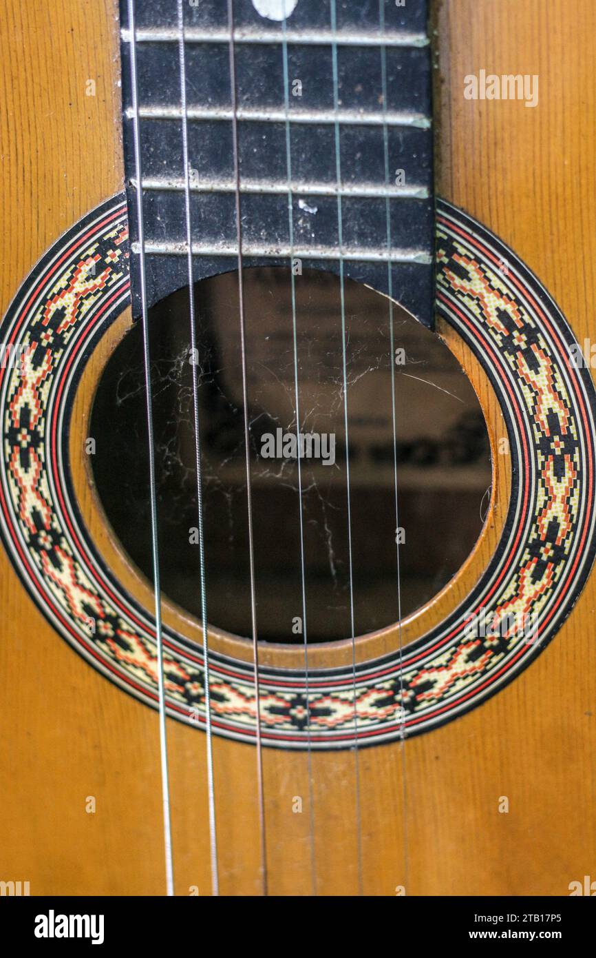 a classical guitar pickup hole with spider web Stock Photo - Alamy