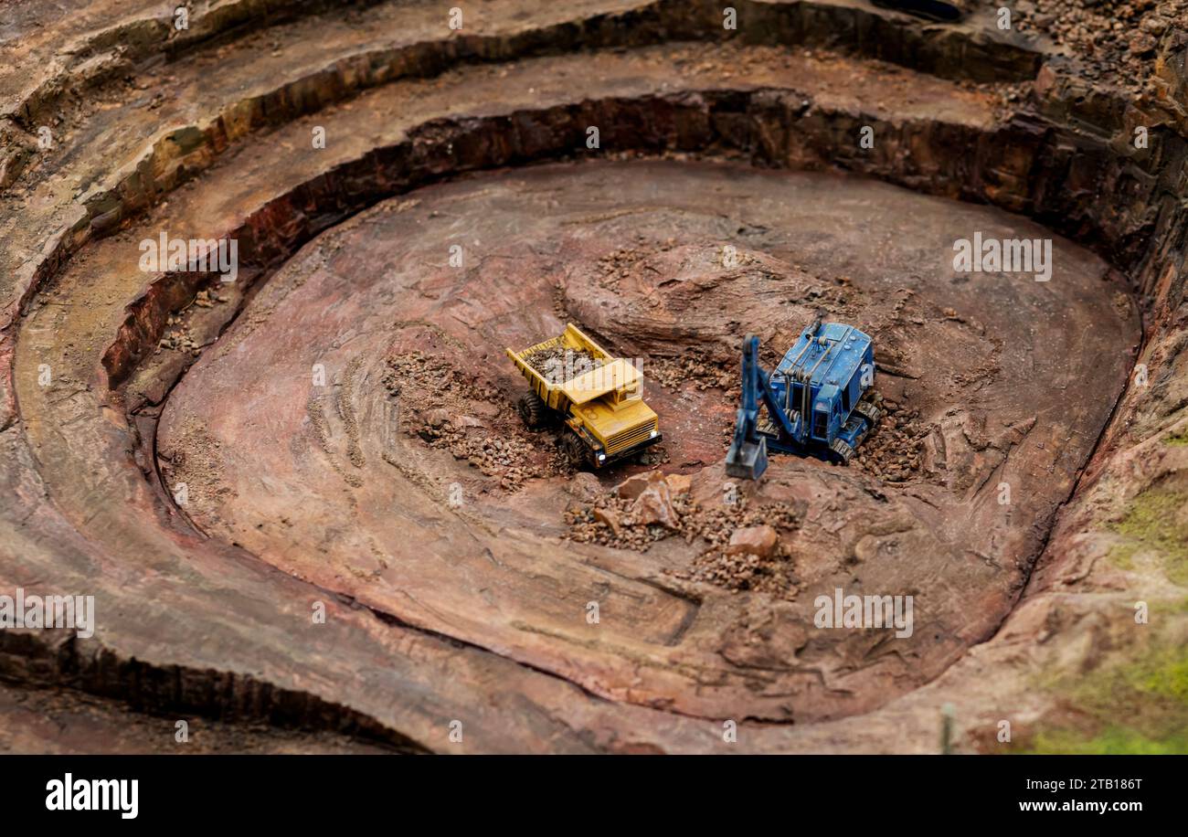 miniature model of a dump truck and excavator in quarry. construction ...